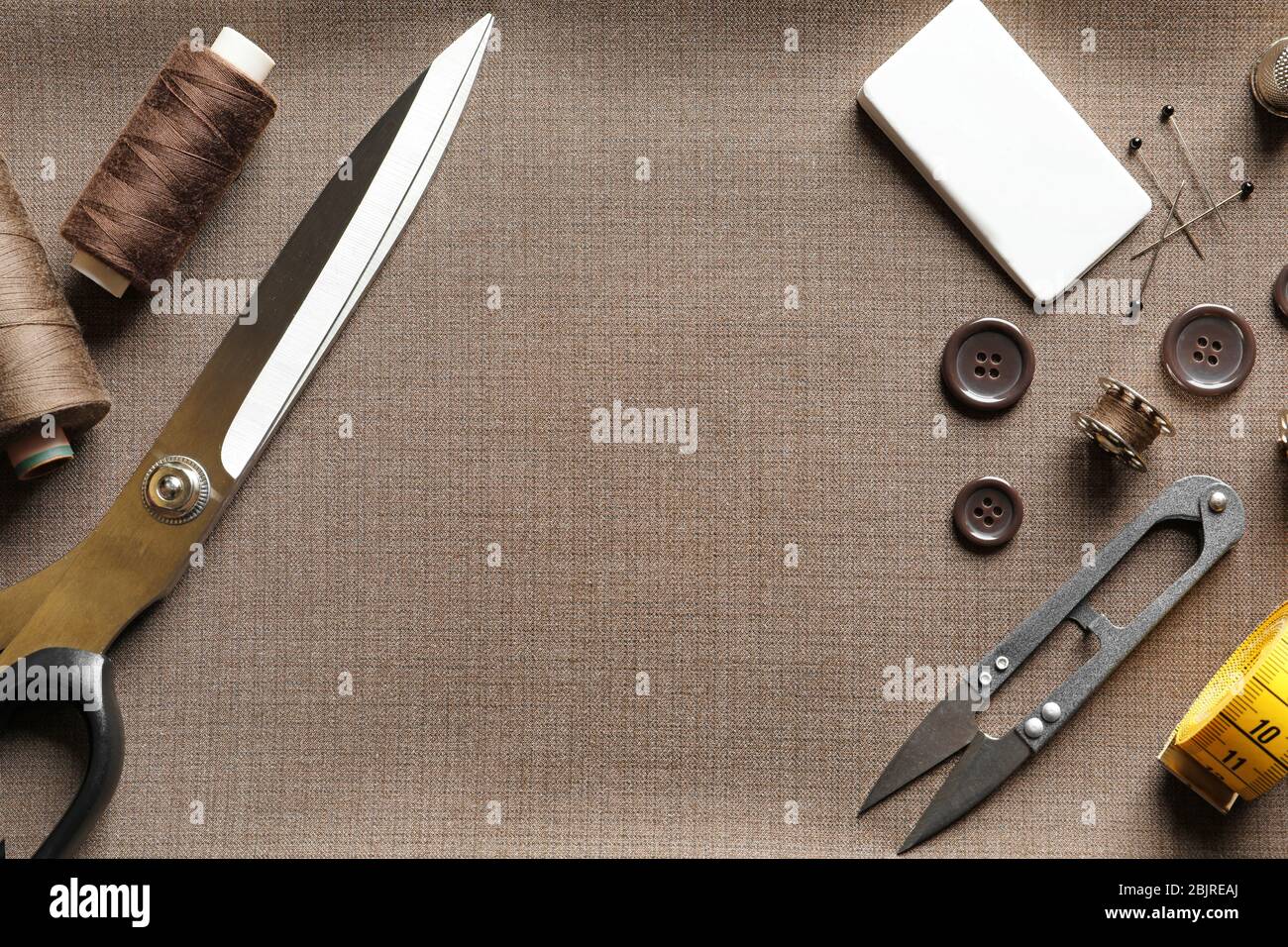 Set of tailoring tools and accessories on fabric, top view Stock Photo ...