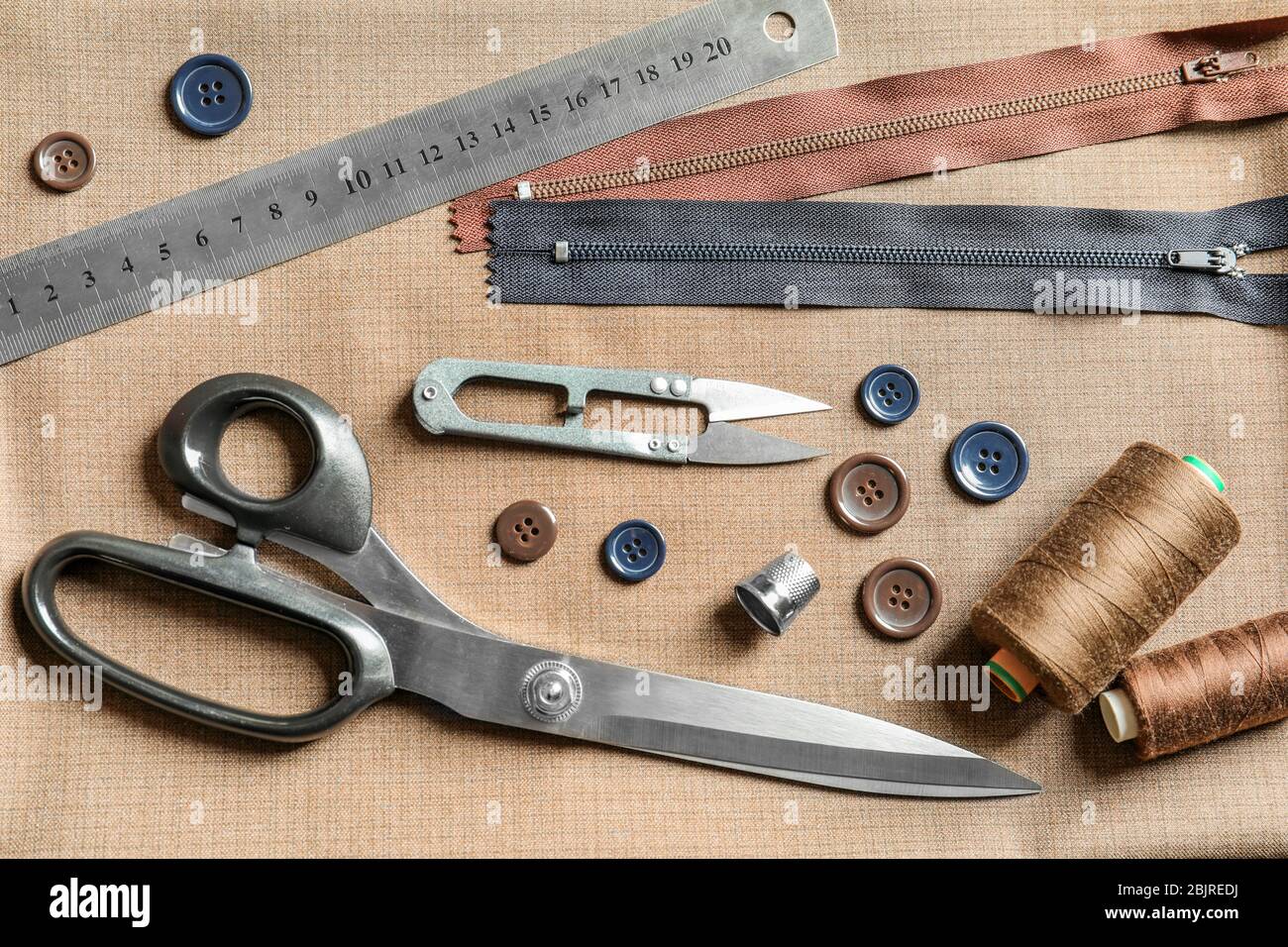 Set of tailoring tools and accessories on fabric, top view Stock Photo ...