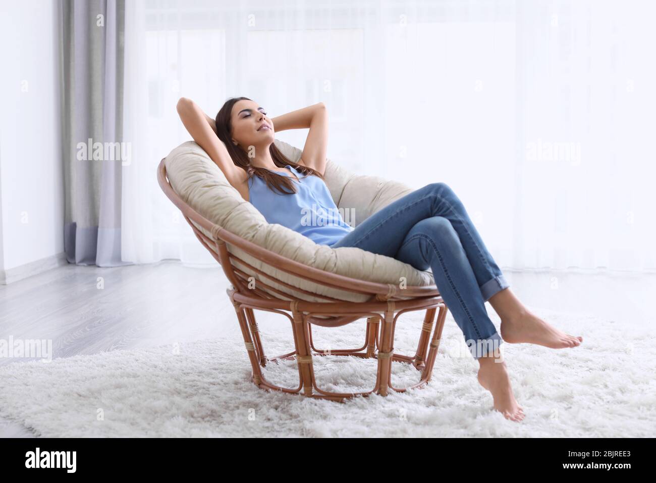 Woman sleeping in lounge chair hi-res stock photography and images - Alamy