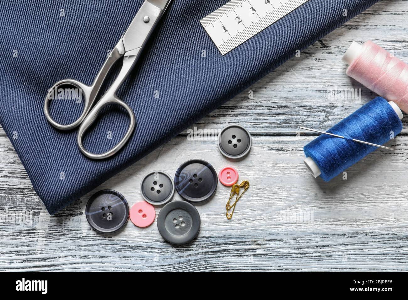 Set of tailoring tools and accessories on table, top view Stock Photo ...