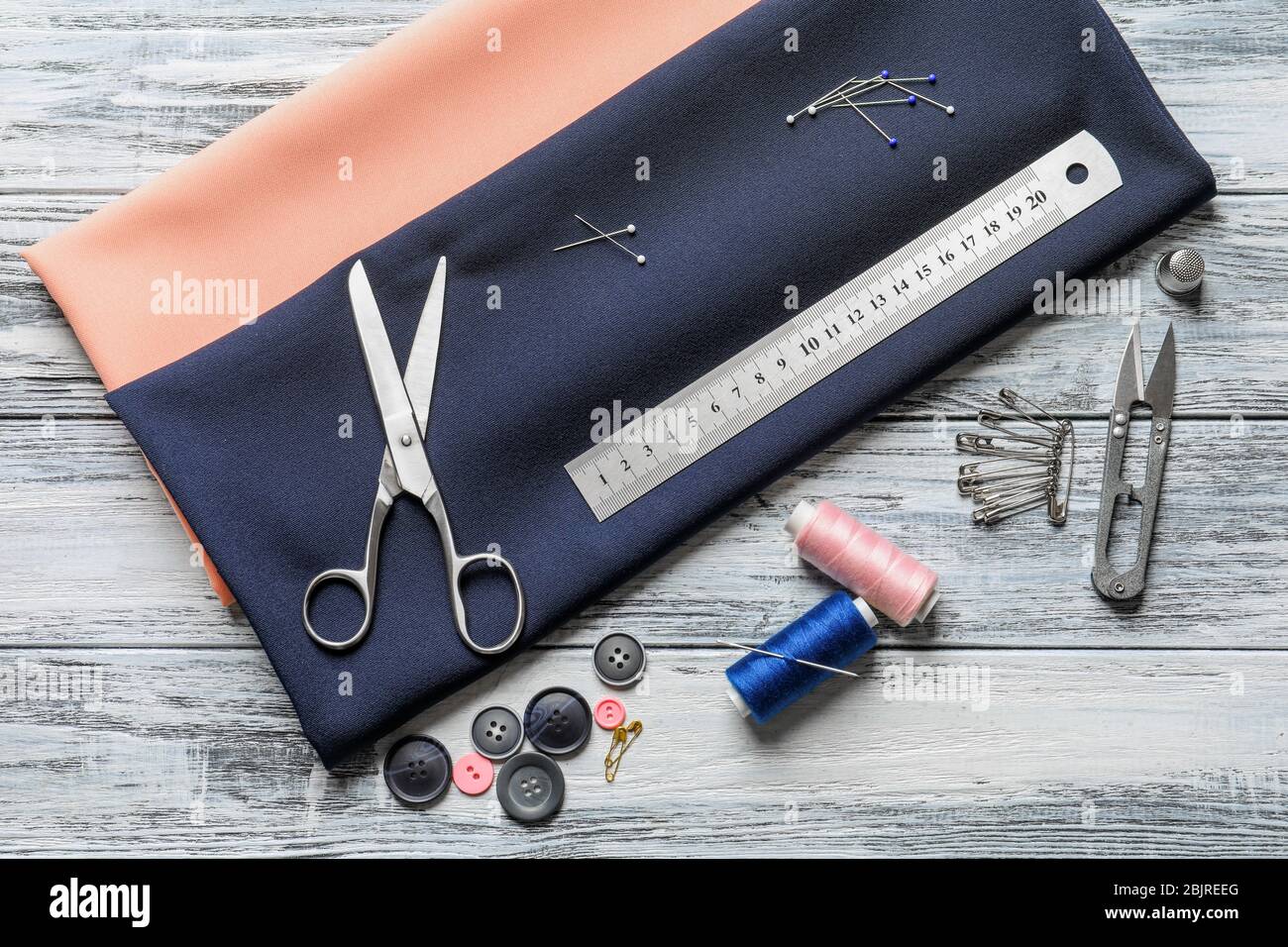 Set of tailoring tools and accessories on table, top view Stock Photo ...