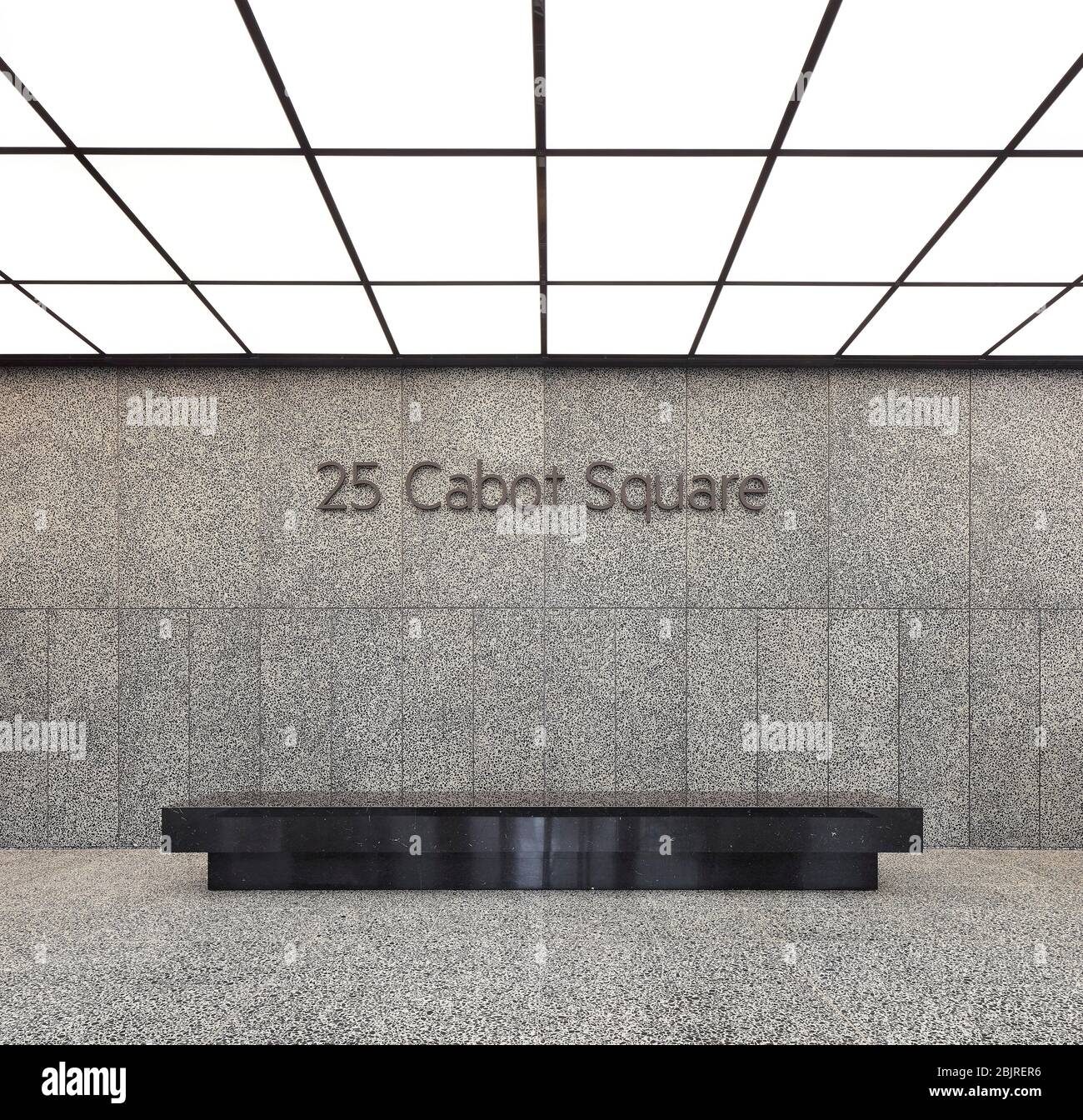 Corporate reception space with illuminated ceiling and granite bench ...