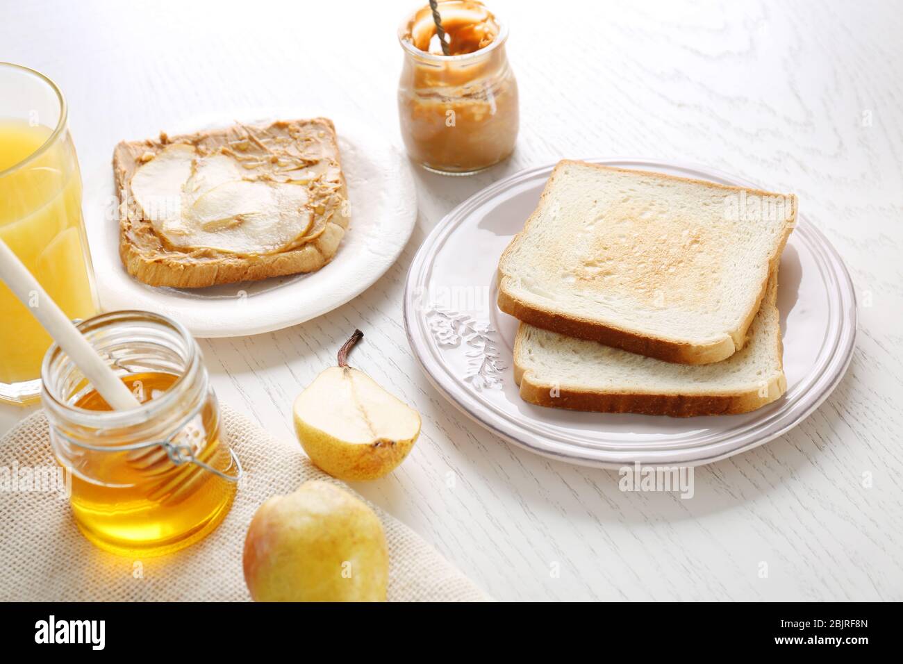 Delicious toasts served for breakfast on wooden table Stock Photo - Alamy
