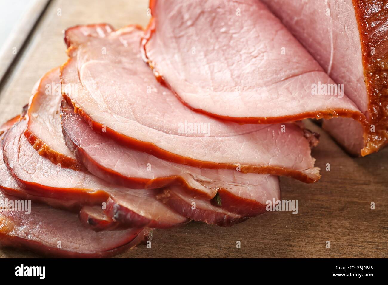 Delicious sliced honey baked ham on wooden board, closeup Stock Photo ...