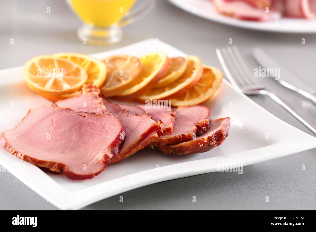 Plate with sliced honey baked ham on table, closeup Stock Photo - Alamy
