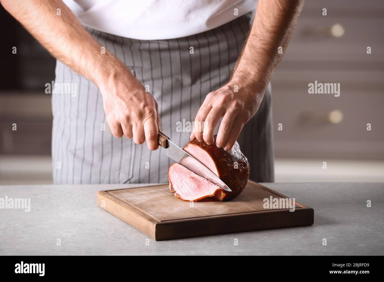 Chef slicing yummy honey baked ham on wooden board Stock Photo - Alamy