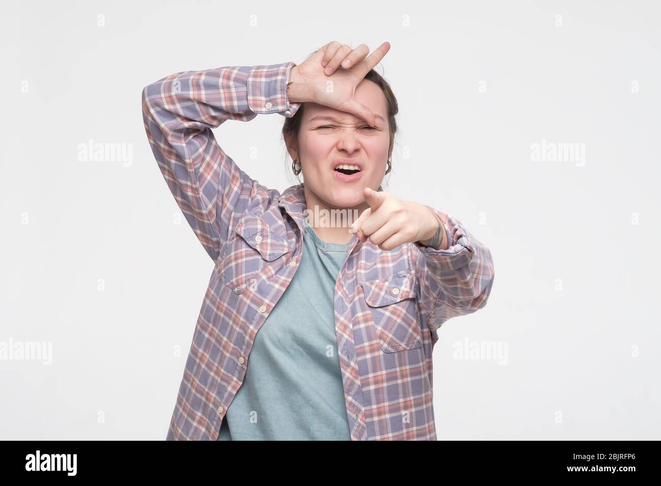 You are outsider. Annoyed good looking woman, tilting head and showing ...