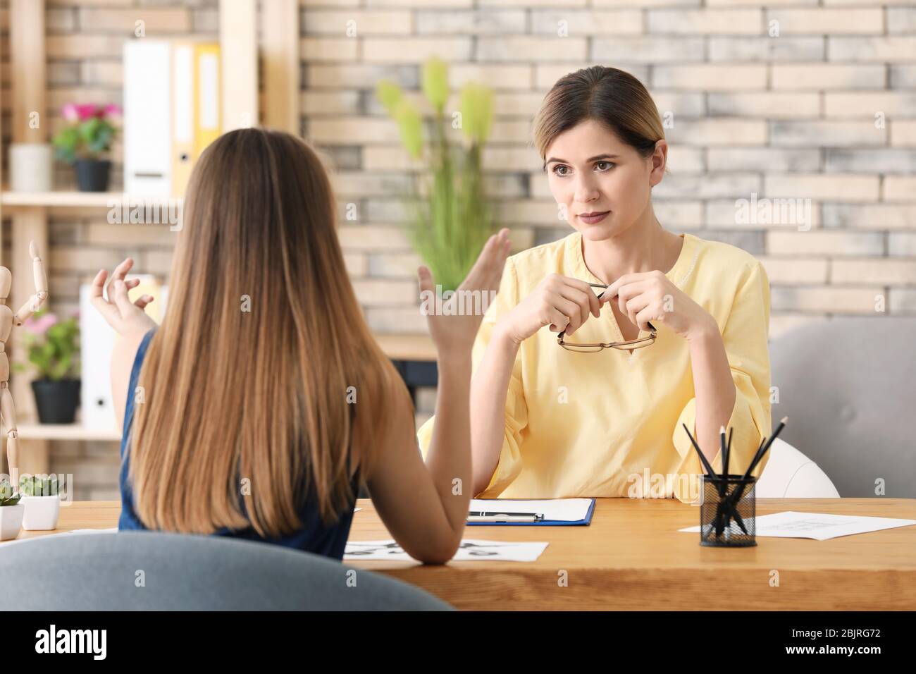 Female psychologist working with patient in office Stock Photo - Alamy