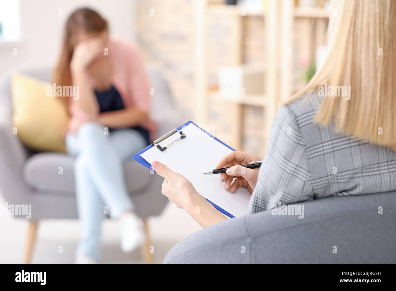 Female psychologist working with patient in office Stock Photo - Alamy