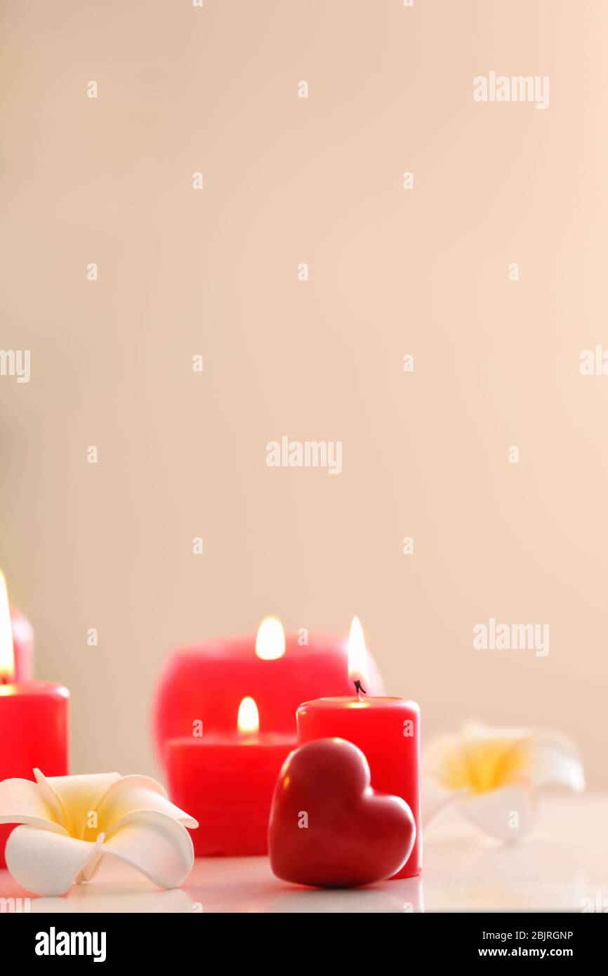 Burning red candles on table Stock Photo - Alamy