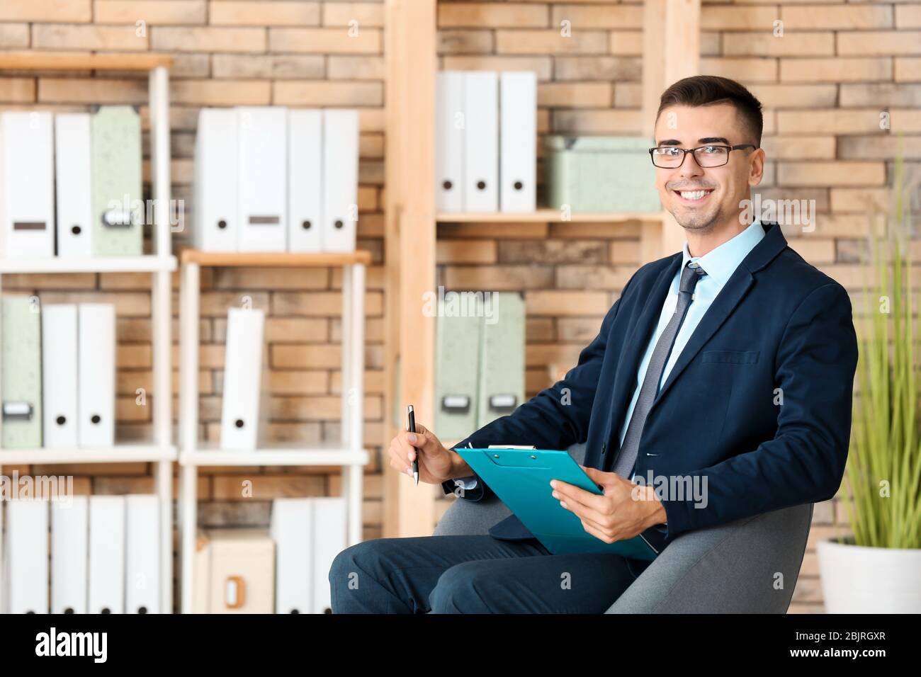 Handsome male psychologist in office Stock Photo - Alamy