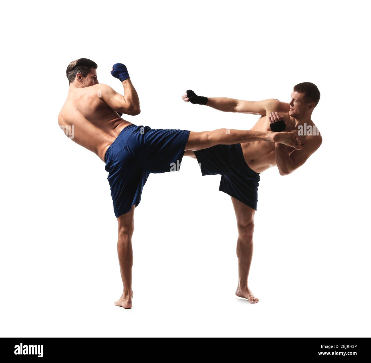 Attractive young kickboxers fighting on white background Stock Photo ...