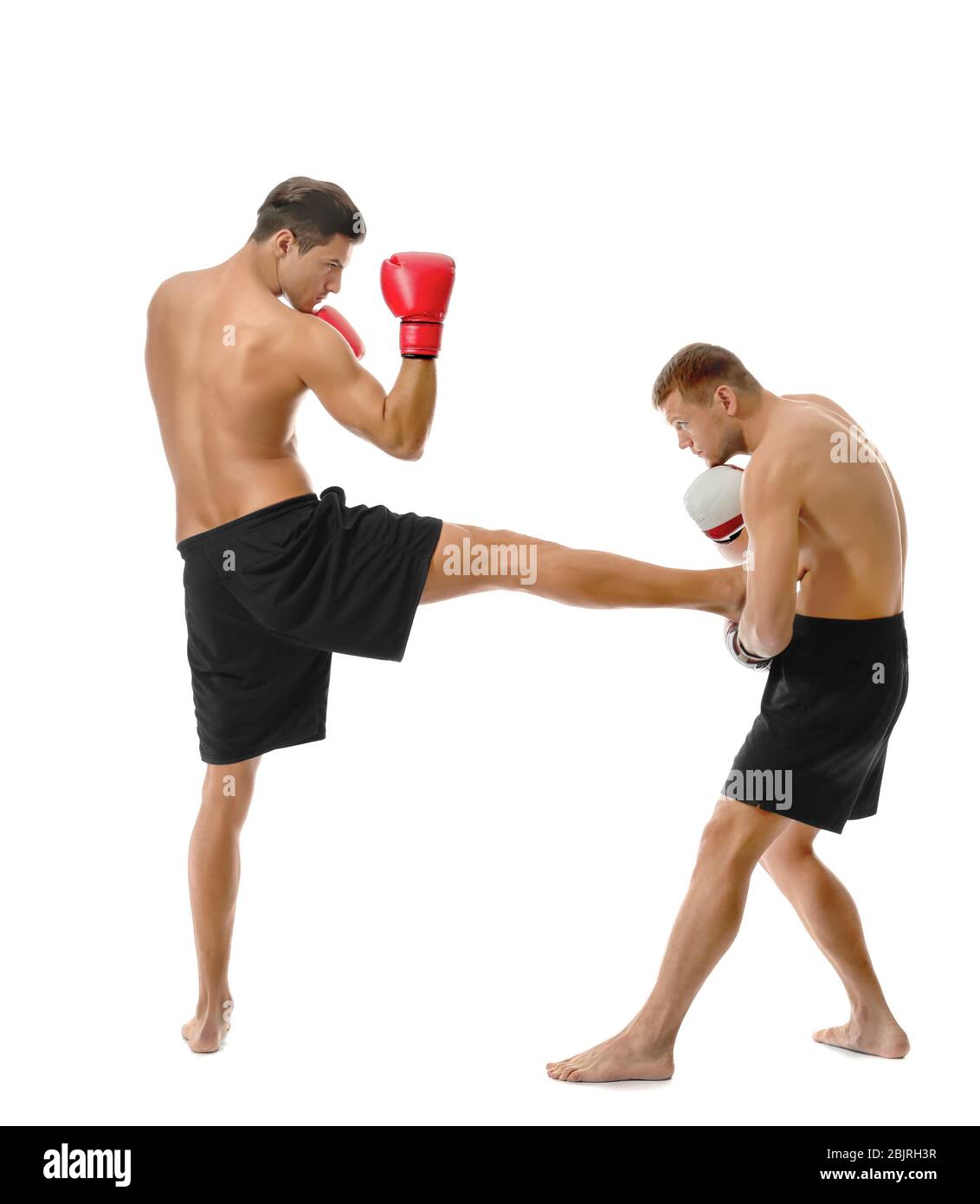 Attractive young kickboxers fighting on white background Stock Photo ...