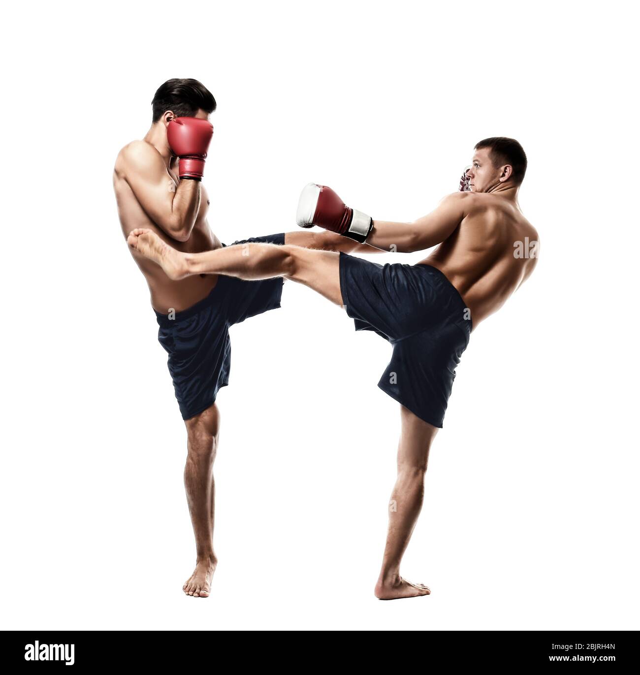 Attractive young kickboxers fighting on white background Stock Photo ...