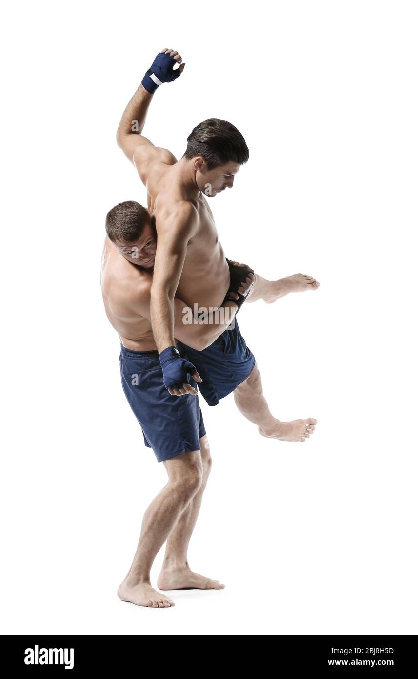 Attractive young men wrestling on white background Stock Photo - Alamy