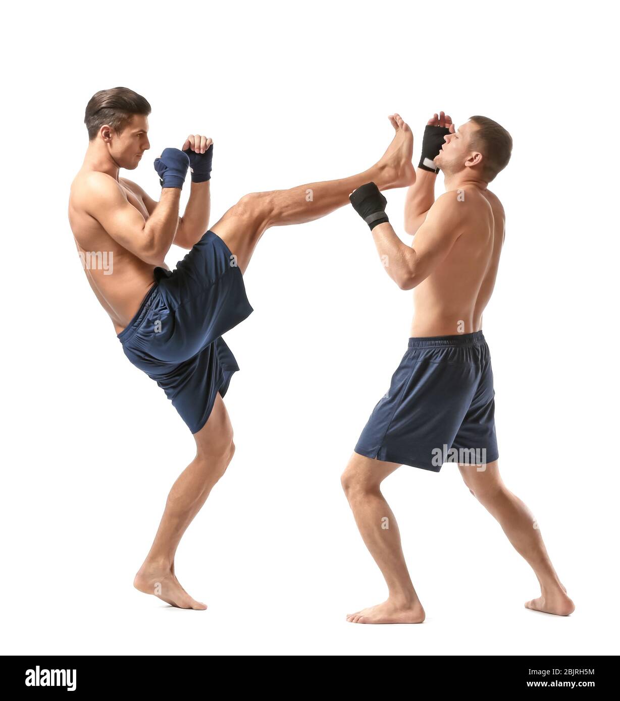 Attractive young kickboxers fighting on white background Stock Photo ...