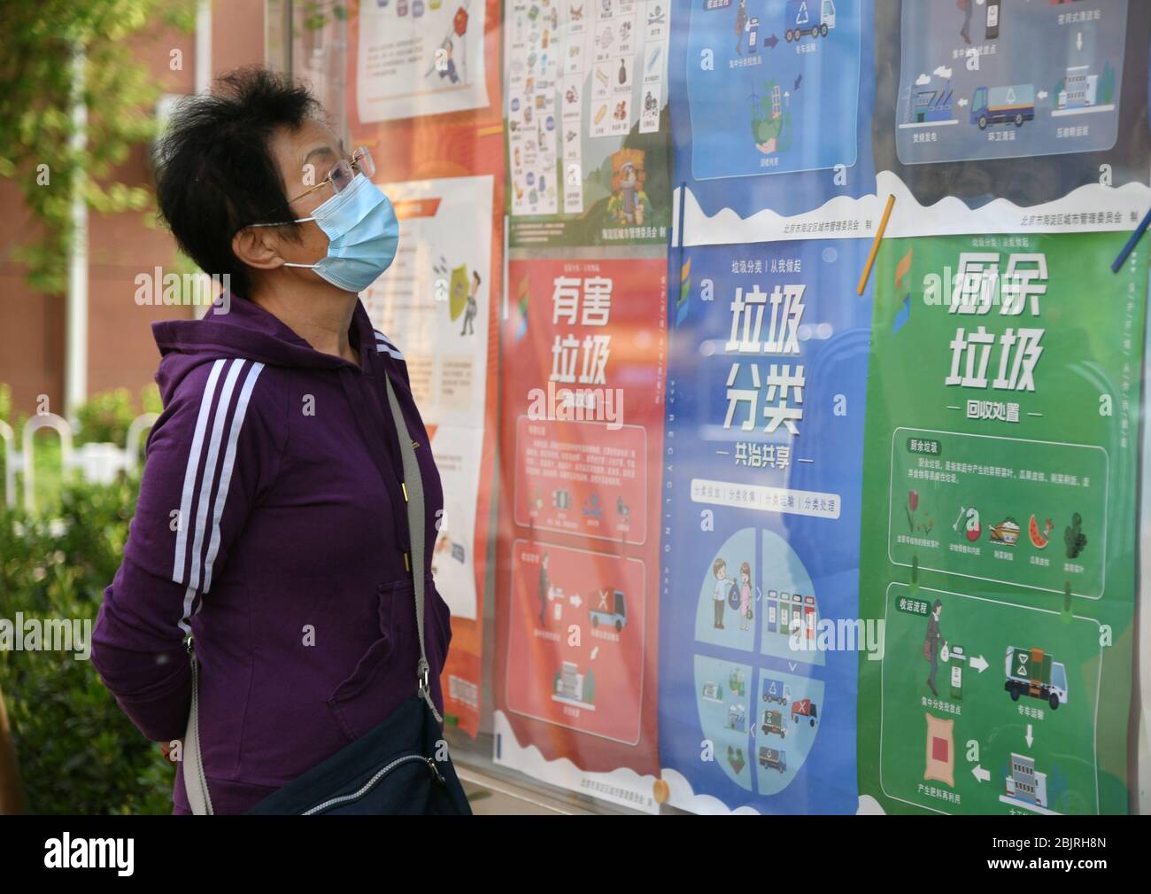 Beijing, China. 30th Apr, 2020. A local resident learns about garbage ...