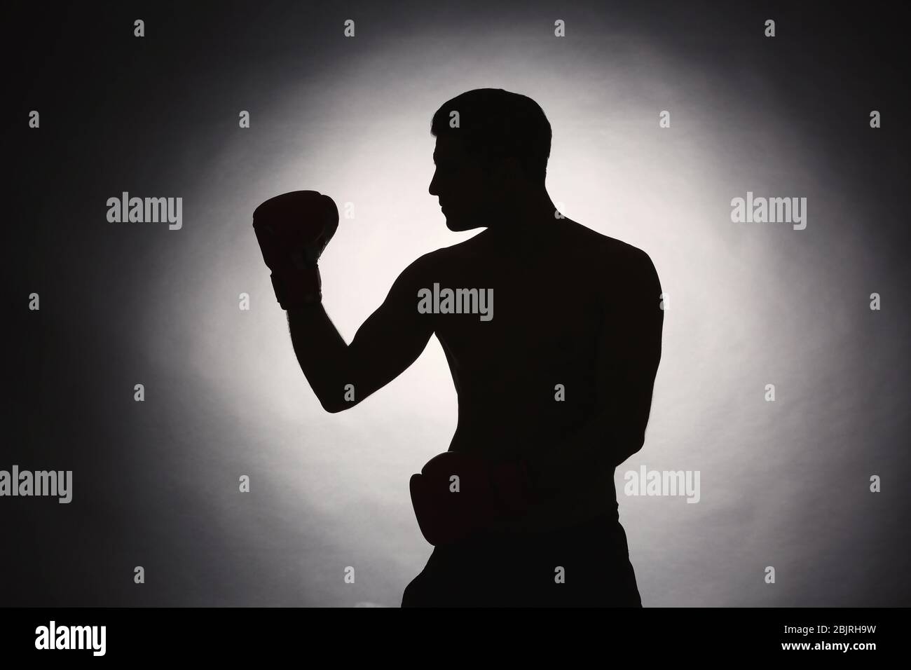 Silhouette of strong male boxer on dark background Stock Photo - Alamy