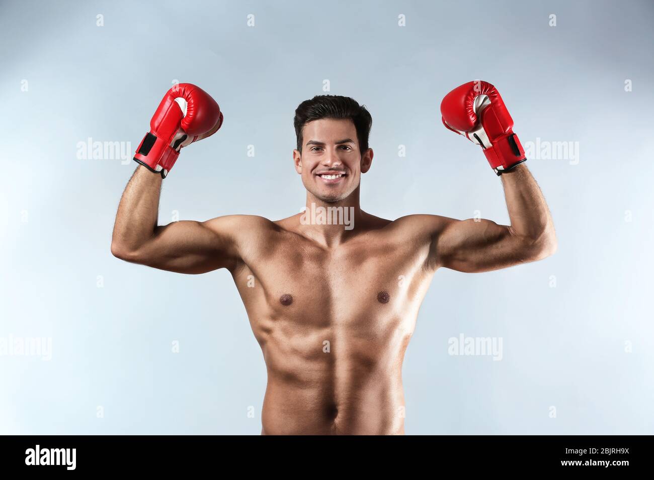 Attractive young boxer on light background Stock Photo - Alamy