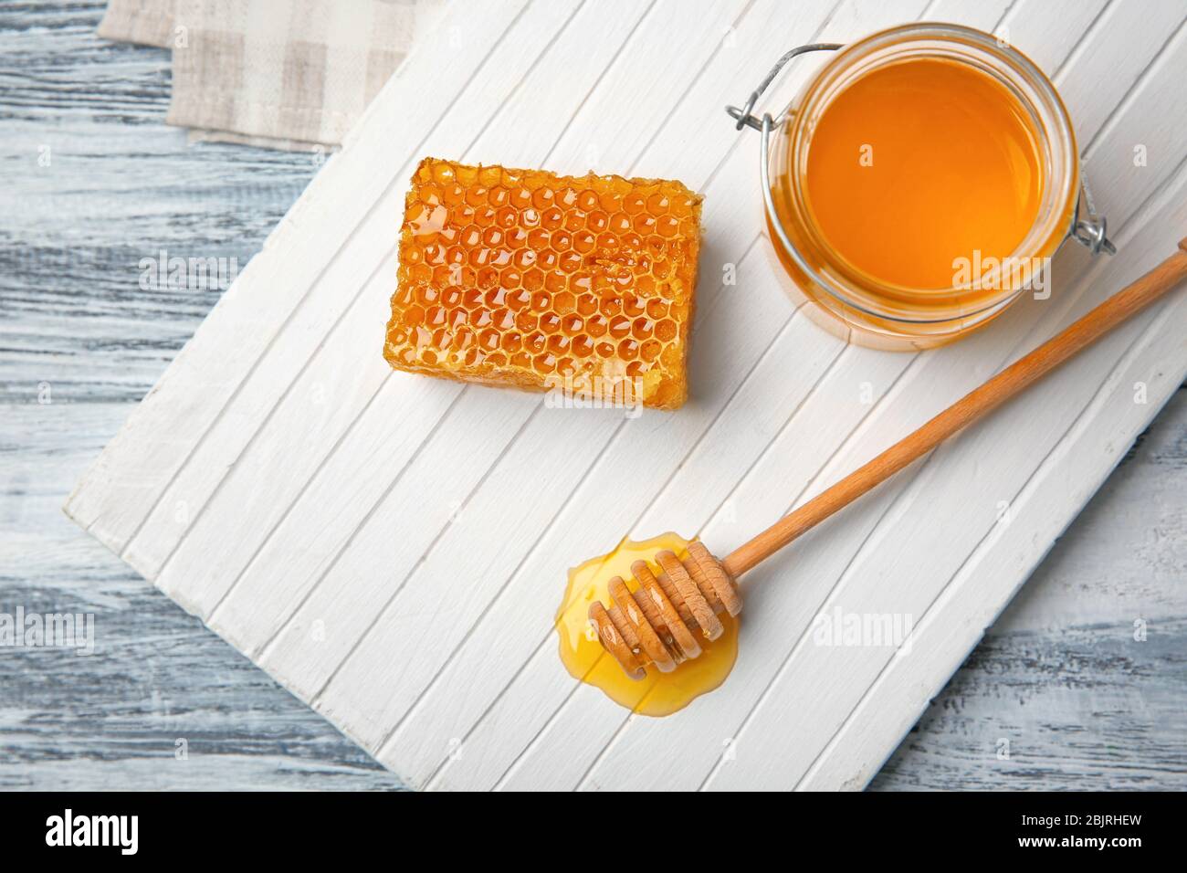 Composition with honey on wooden board, top view Stock Photo - Alamy