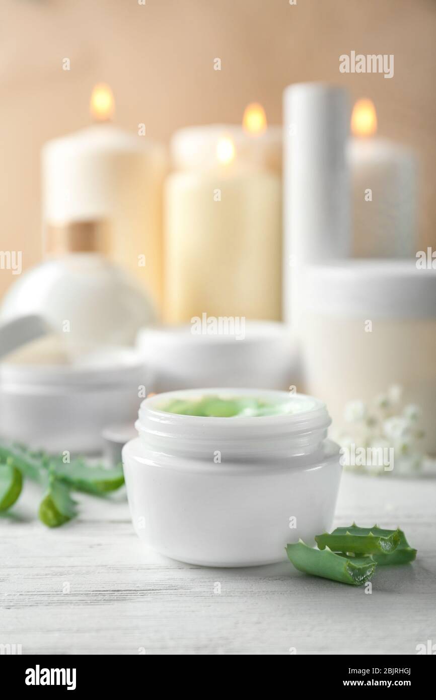 Jar with body cream on wooden table Stock Photo - Alamy