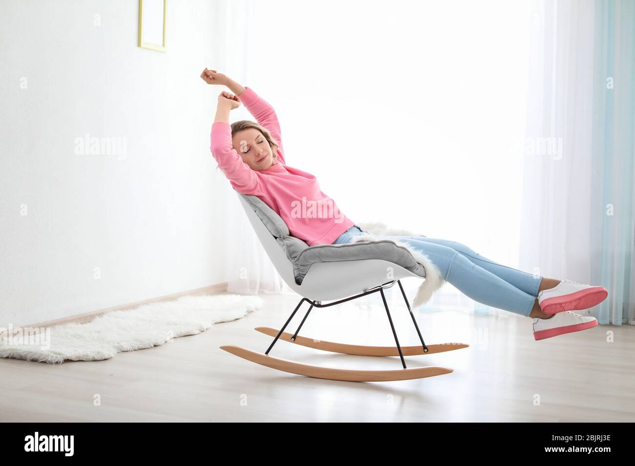 Happy young woman relaxing at home Stock Photo - Alamy