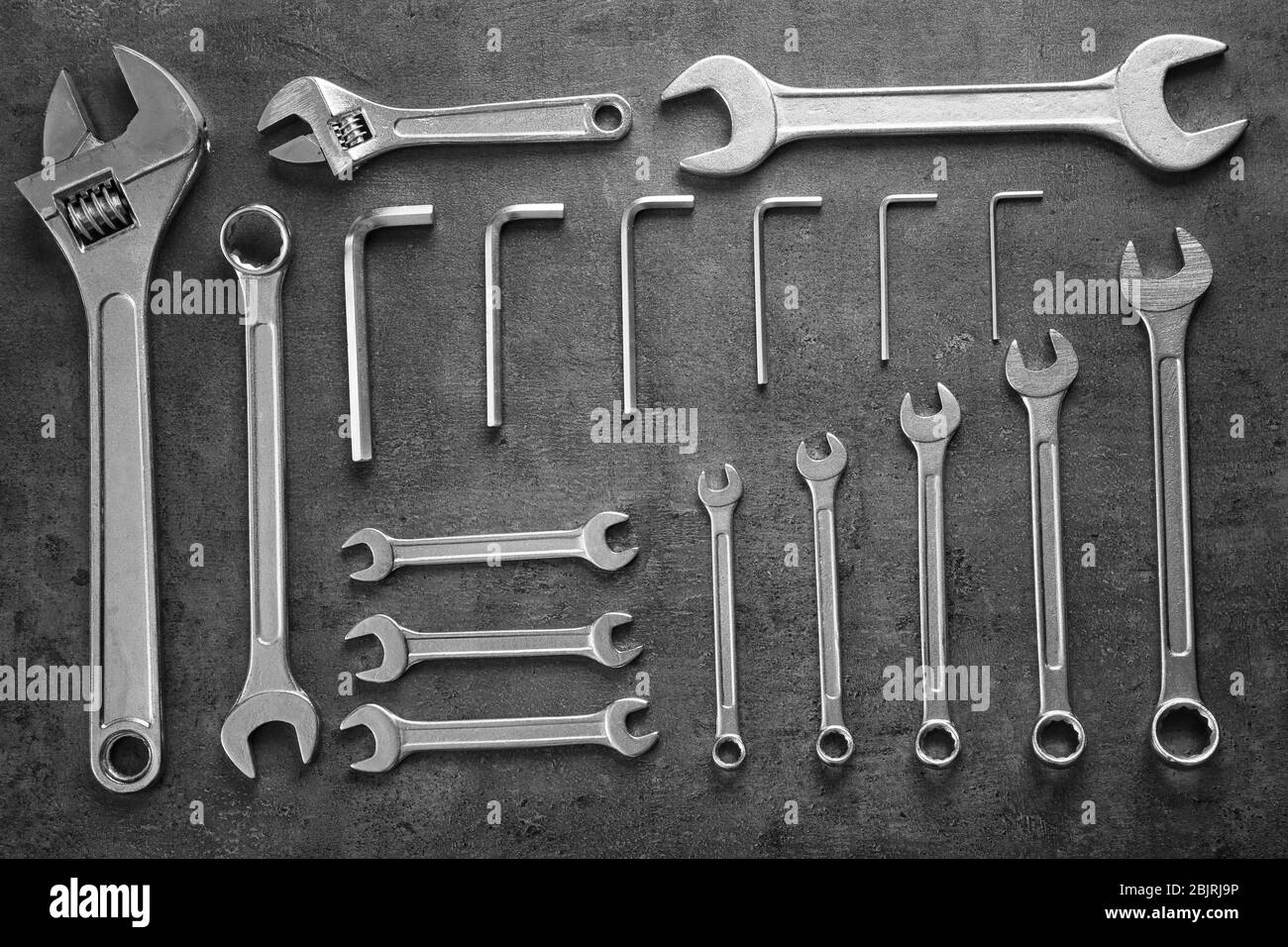 Set of combination wrenches on gray background Stock Photo - Alamy