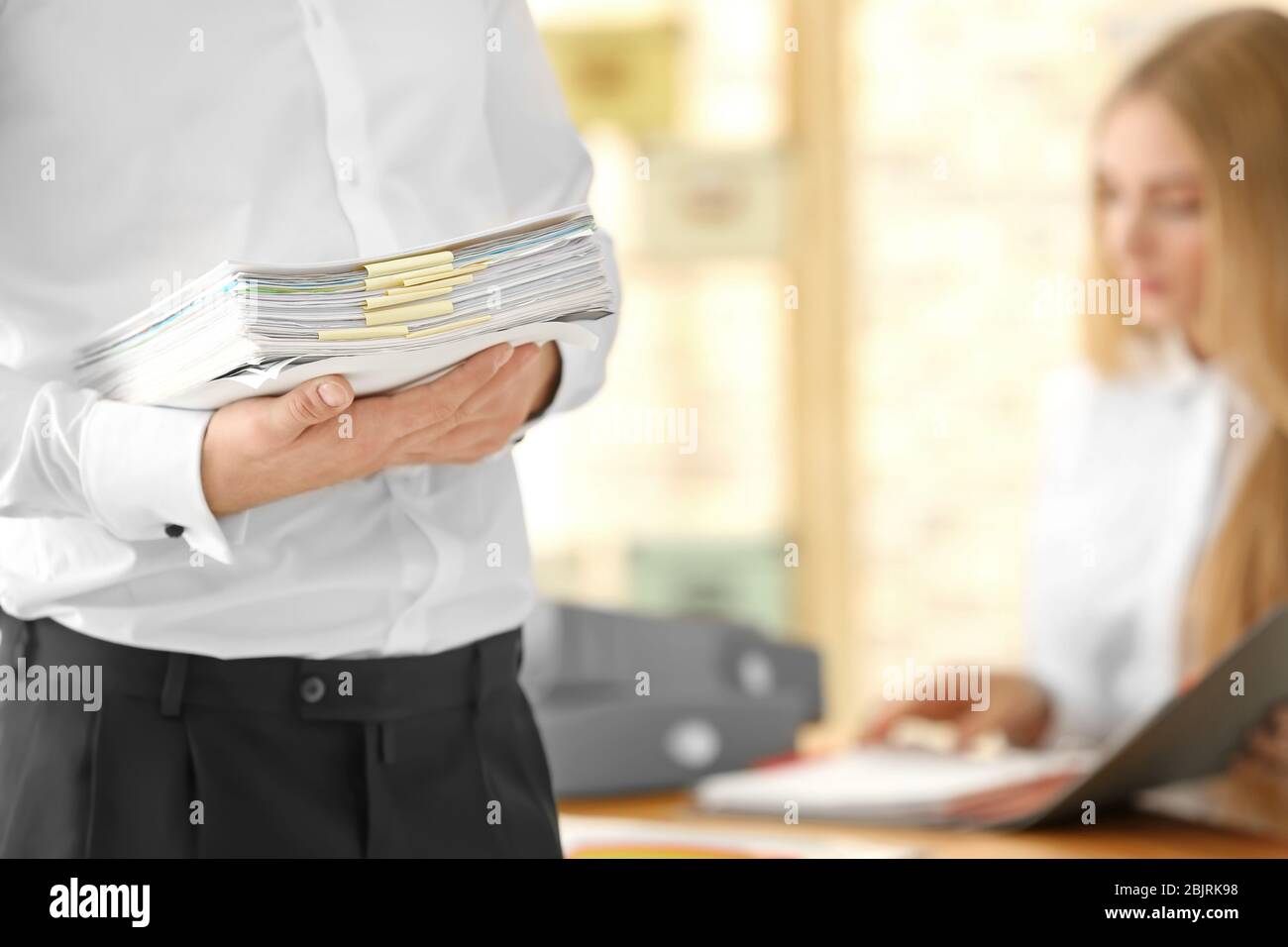 Young man with documents in office Stock Photo - Alamy