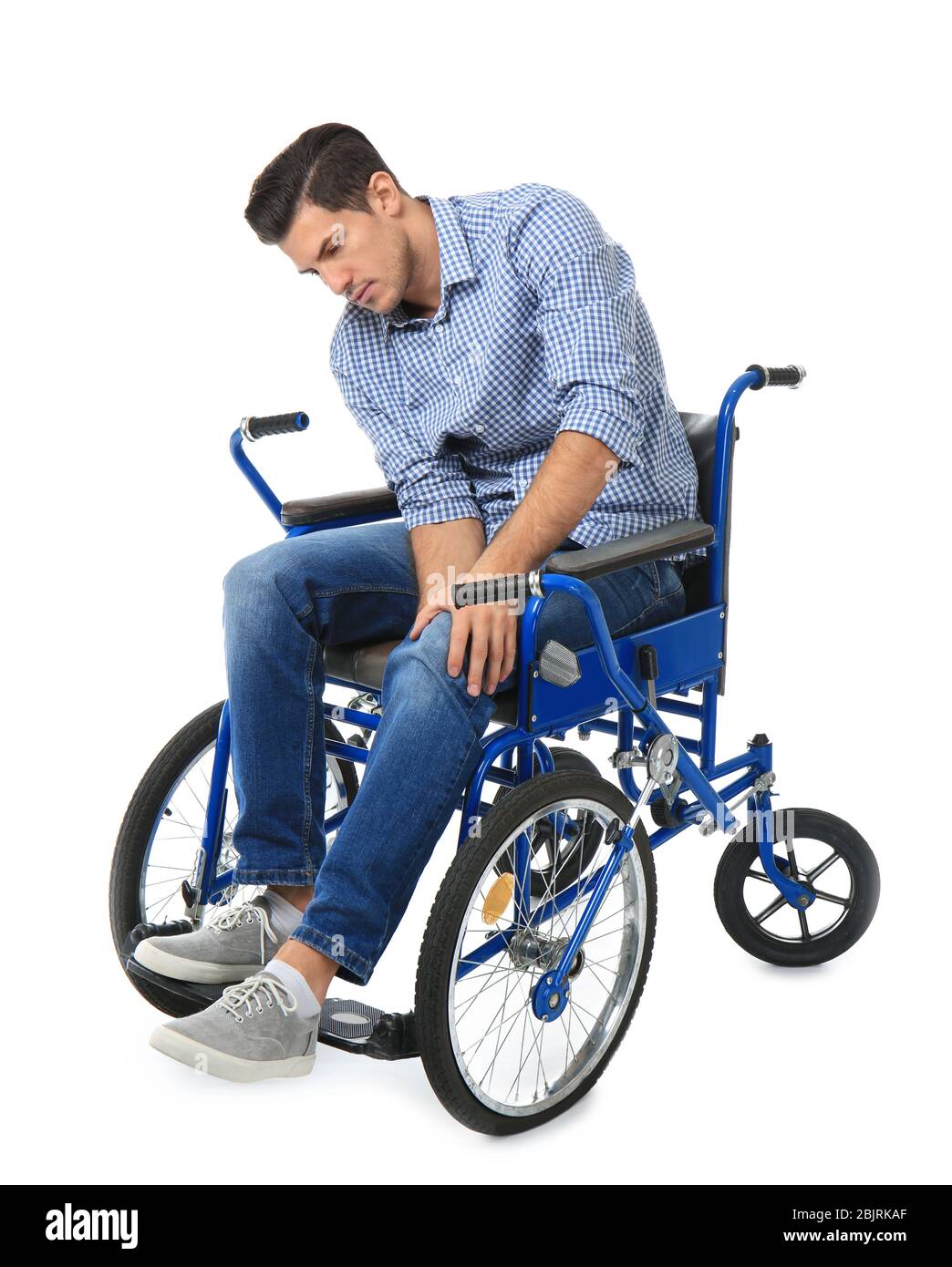 Attractive young man in wheelchair on white background Stock Photo - Alamy