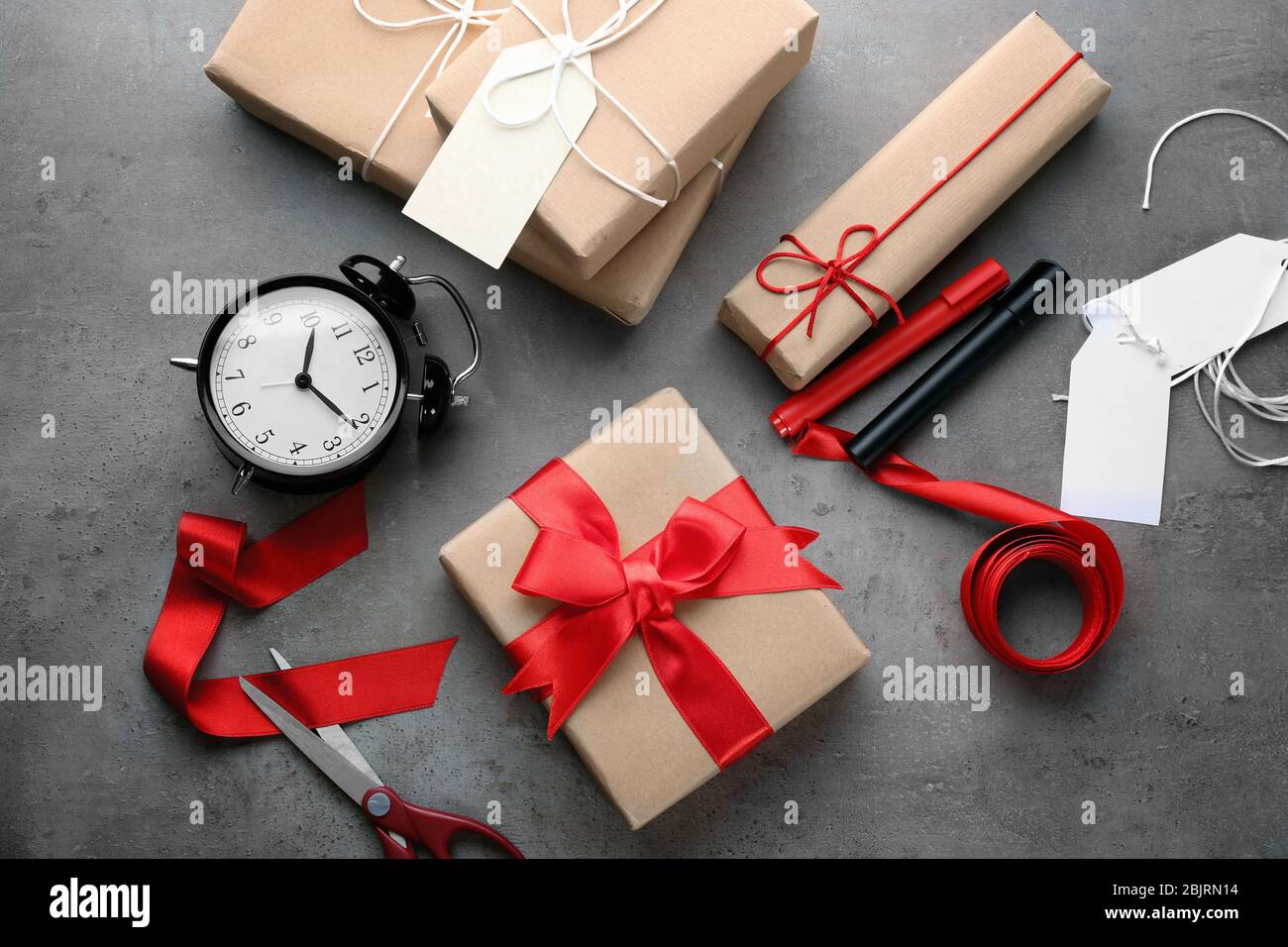 Composition with parcel gift boxes on grey background Stock Photo - Alamy