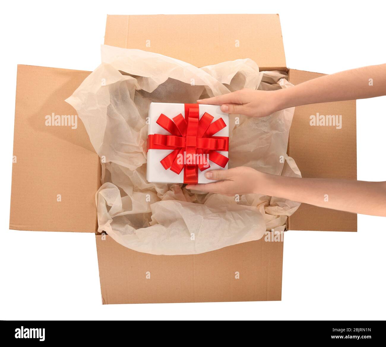 Woman taking gift box out of parcel on white background Stock Photo - Alamy