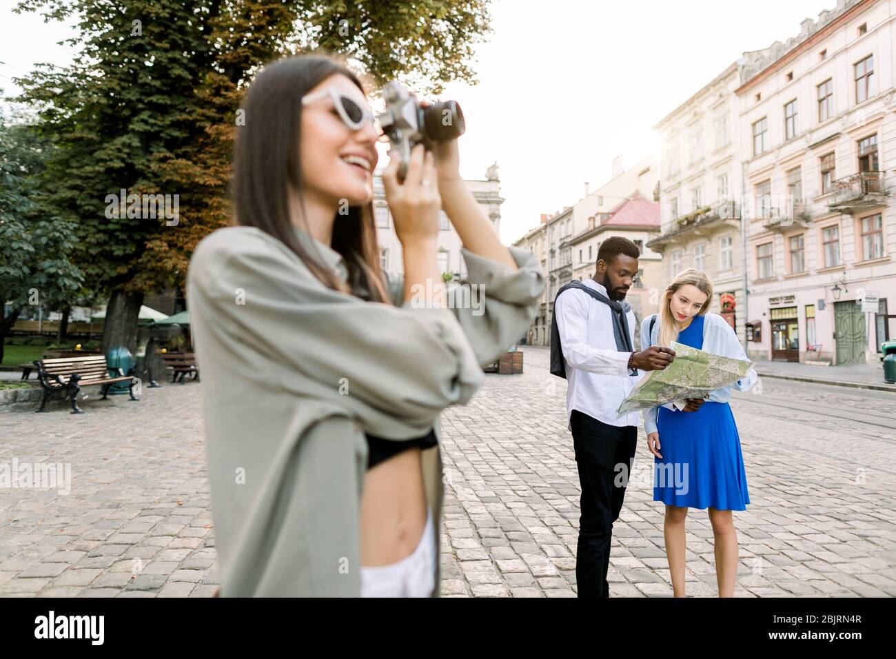 Young beautiful tourist woman exploring the city, making photos of ...
