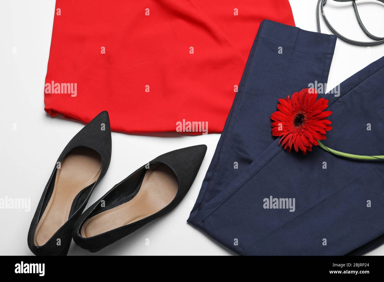 Stylish set of female clothes on white background Stock Photo - Alamy