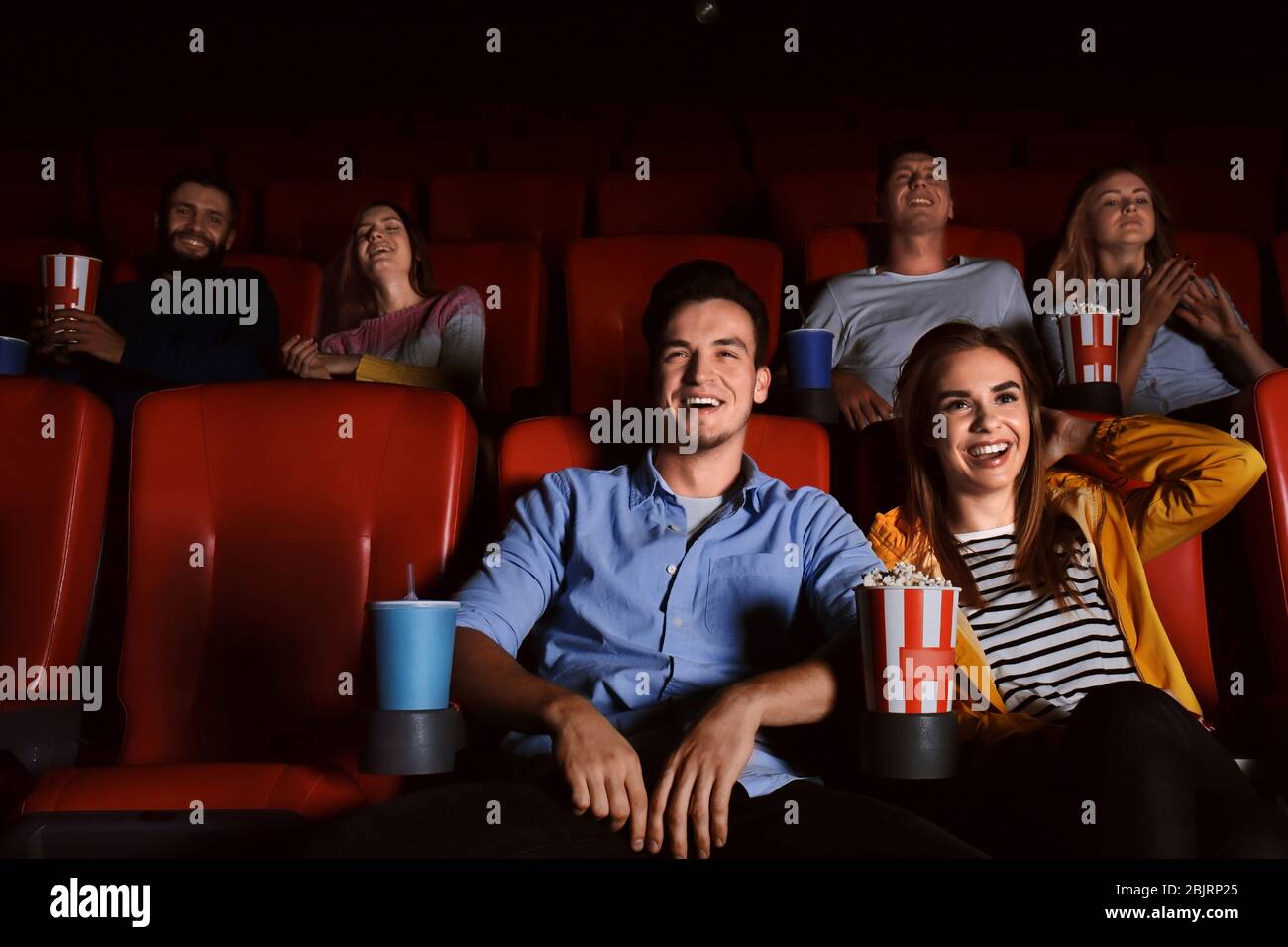 Young people watching movie in cinema Stock Photo - Alamy