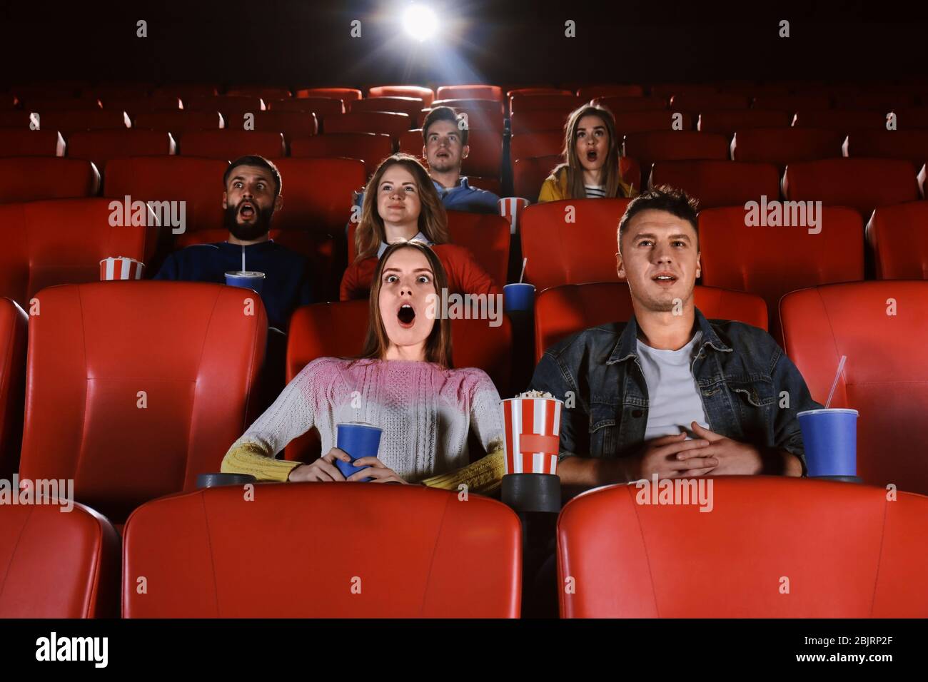 Young people watching movie in cinema Stock Photo - Alamy