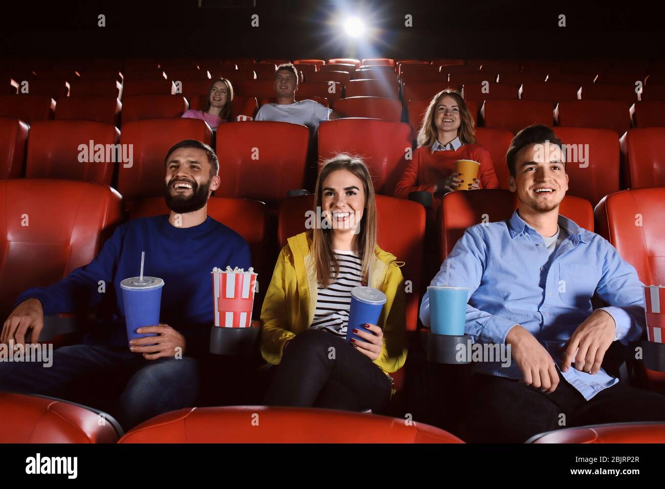 Young people watching movie in cinema Stock Photo - Alamy