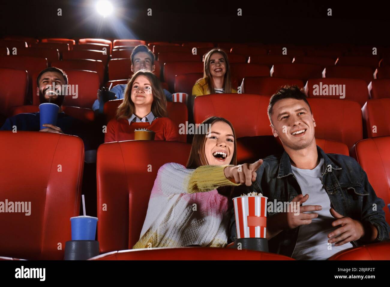 Young people watching movie in cinema Stock Photo - Alamy