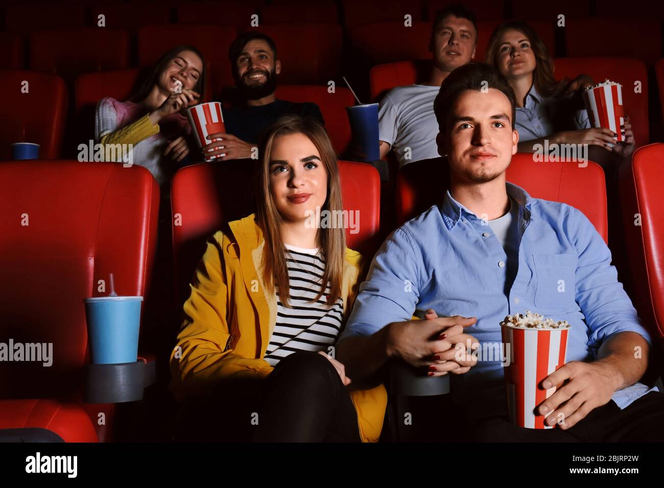 Young people watching movie in cinema Stock Photo - Alamy