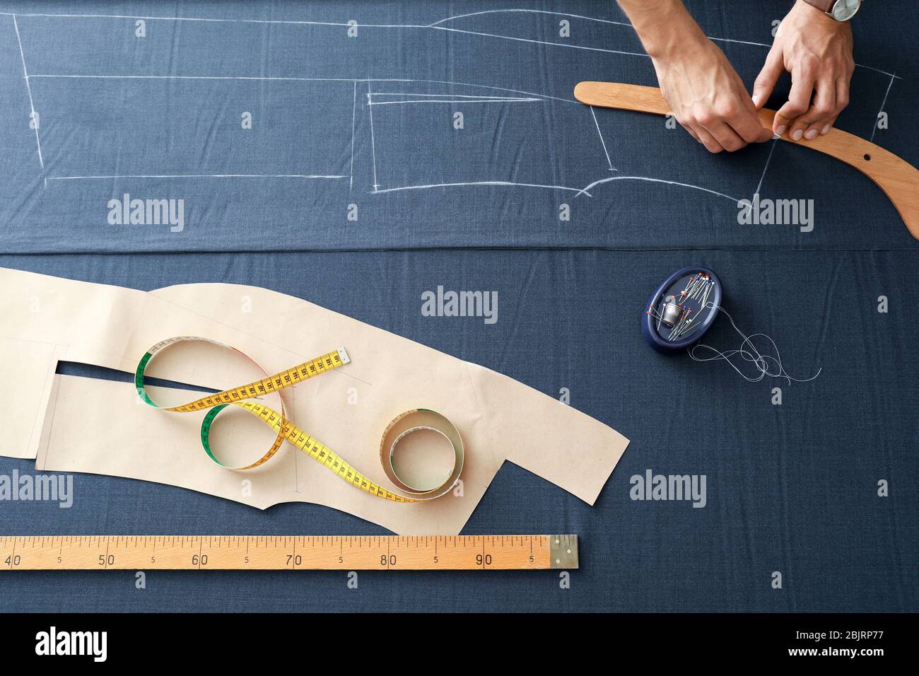Young tailor working with textile Stock Photo - Alamy