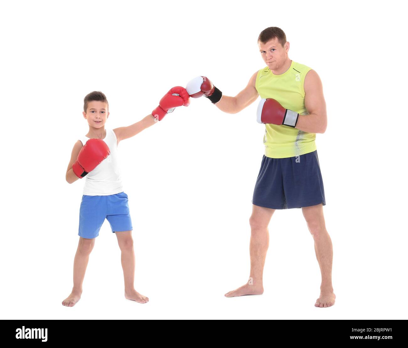 Cute little boy training with boxing coach, on white background Stock ...