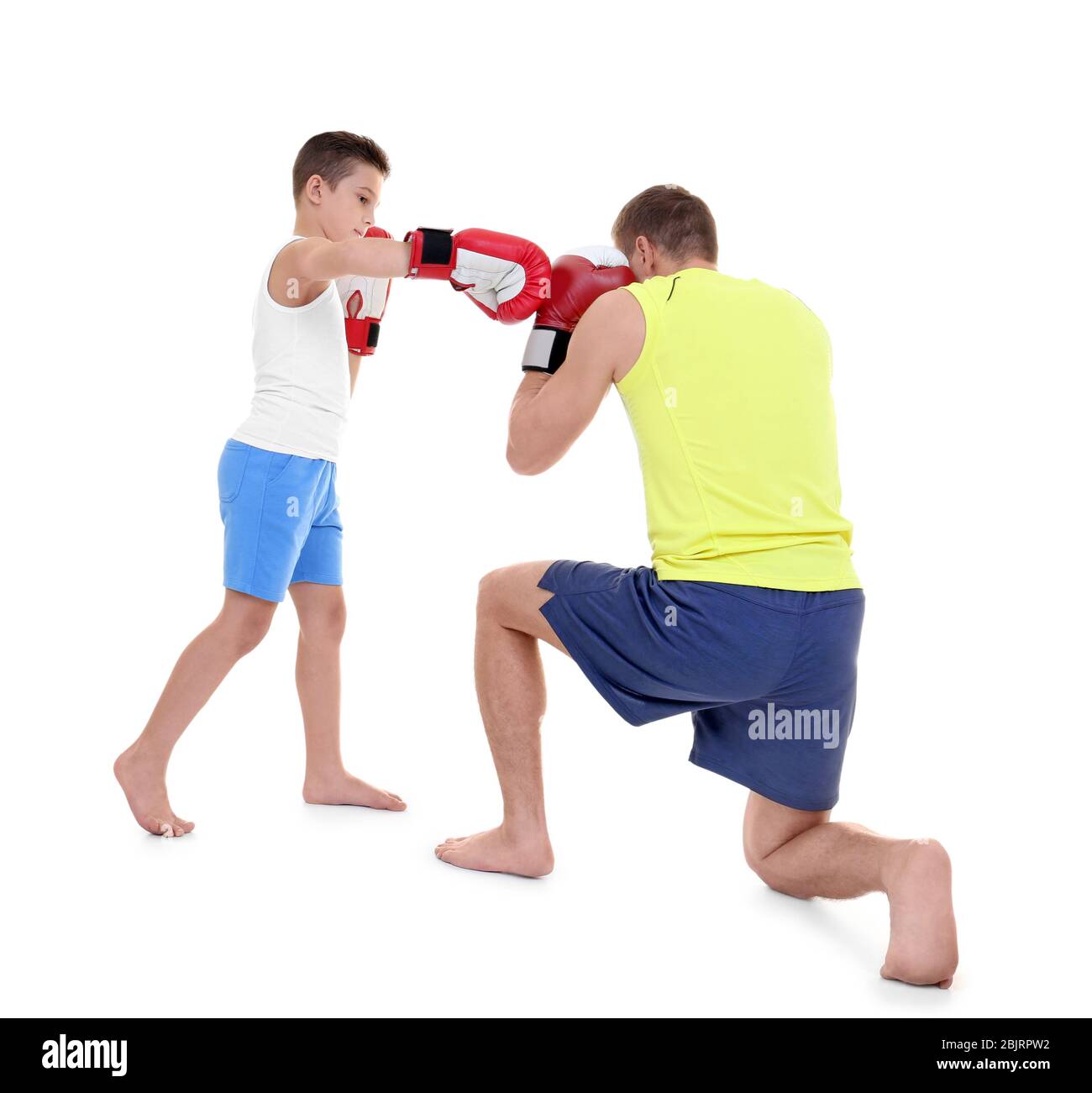 Cute little boy training with boxing coach, on white background Stock ...