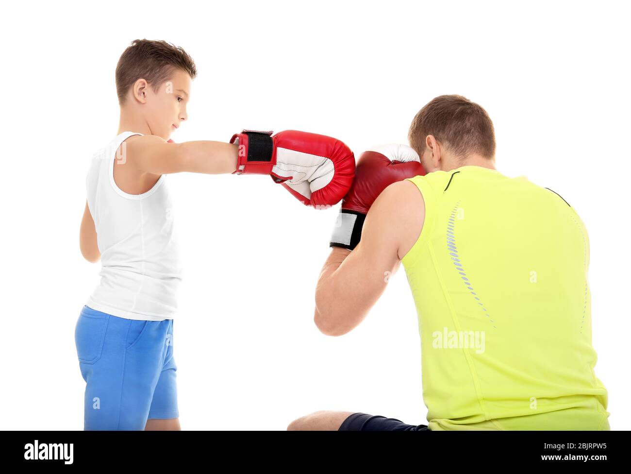Cute little boy training with boxing coach, on white background Stock ...