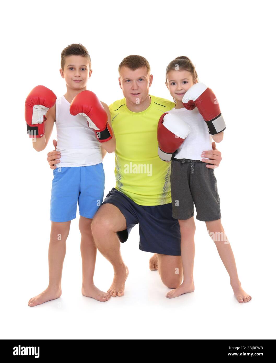 Cute little children with boxing coach on white background Stock Photo ...