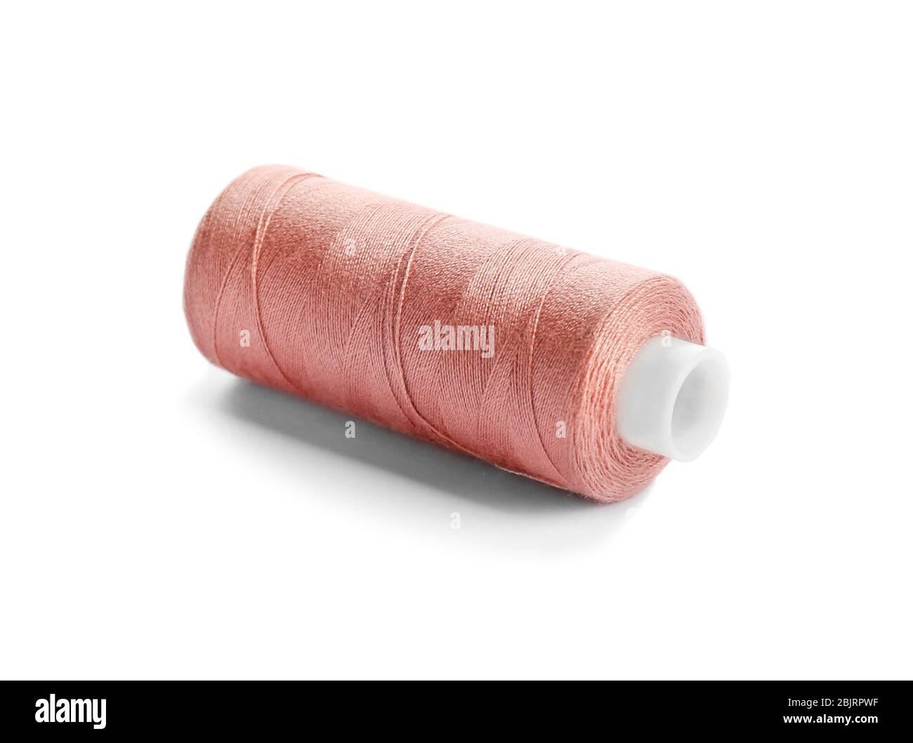 Spool of sewing thread on white background Stock Photo - Alamy