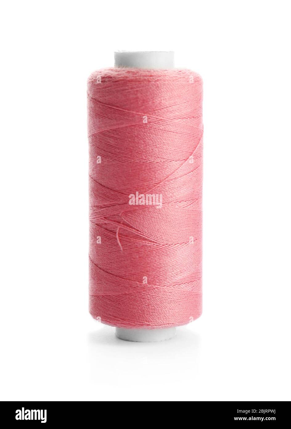 Spool of sewing thread on white background Stock Photo - Alamy