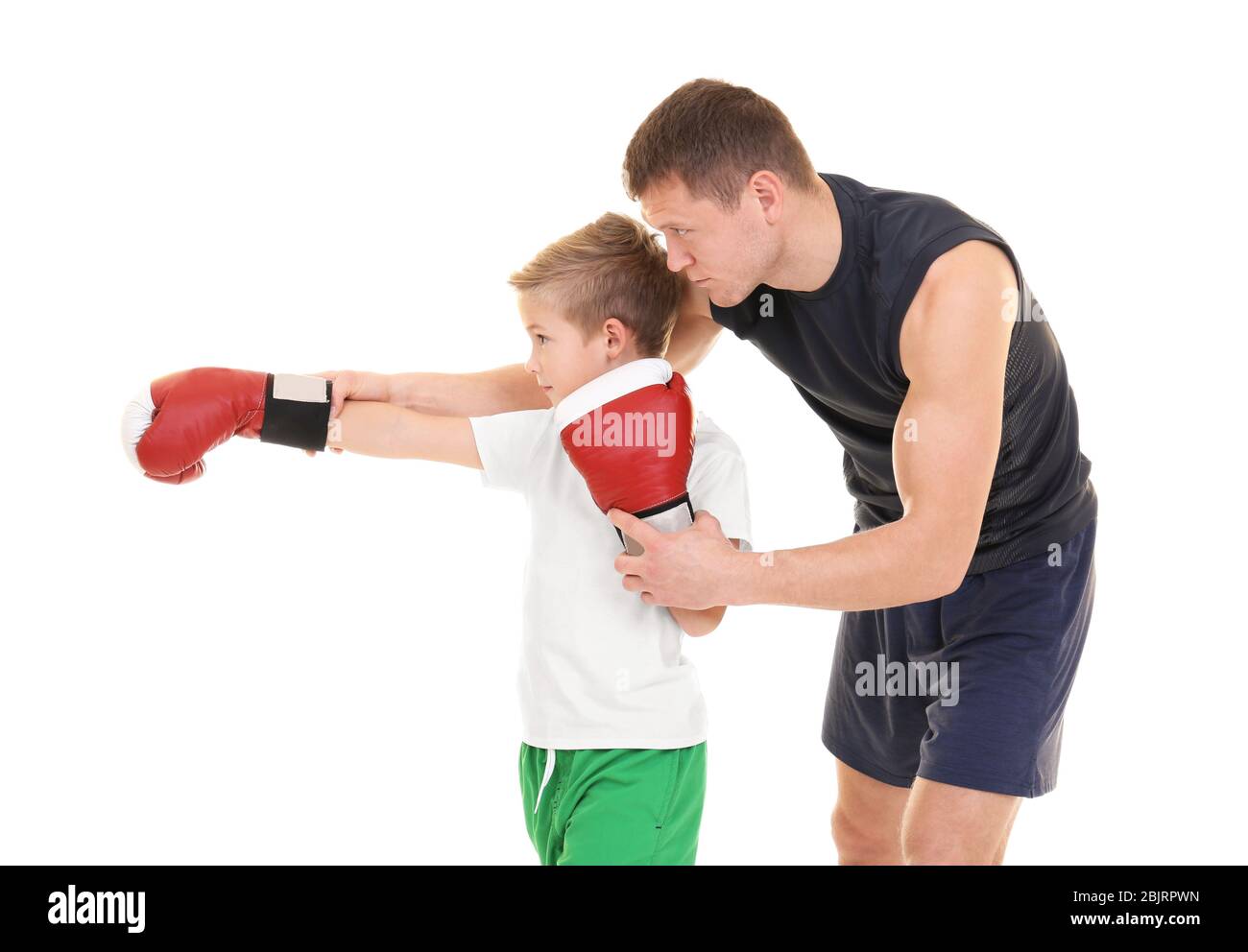 Cute little boy training with boxing coach on white background Stock ...
