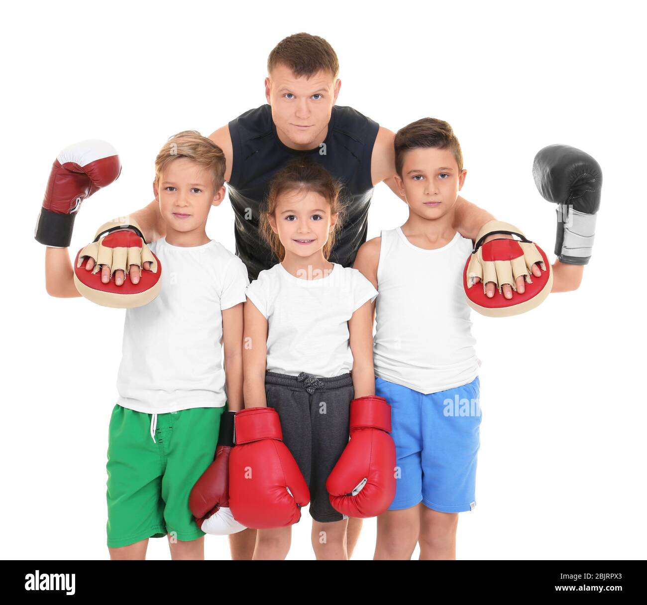 Cute little children in boxing gloves and their coach on white ...