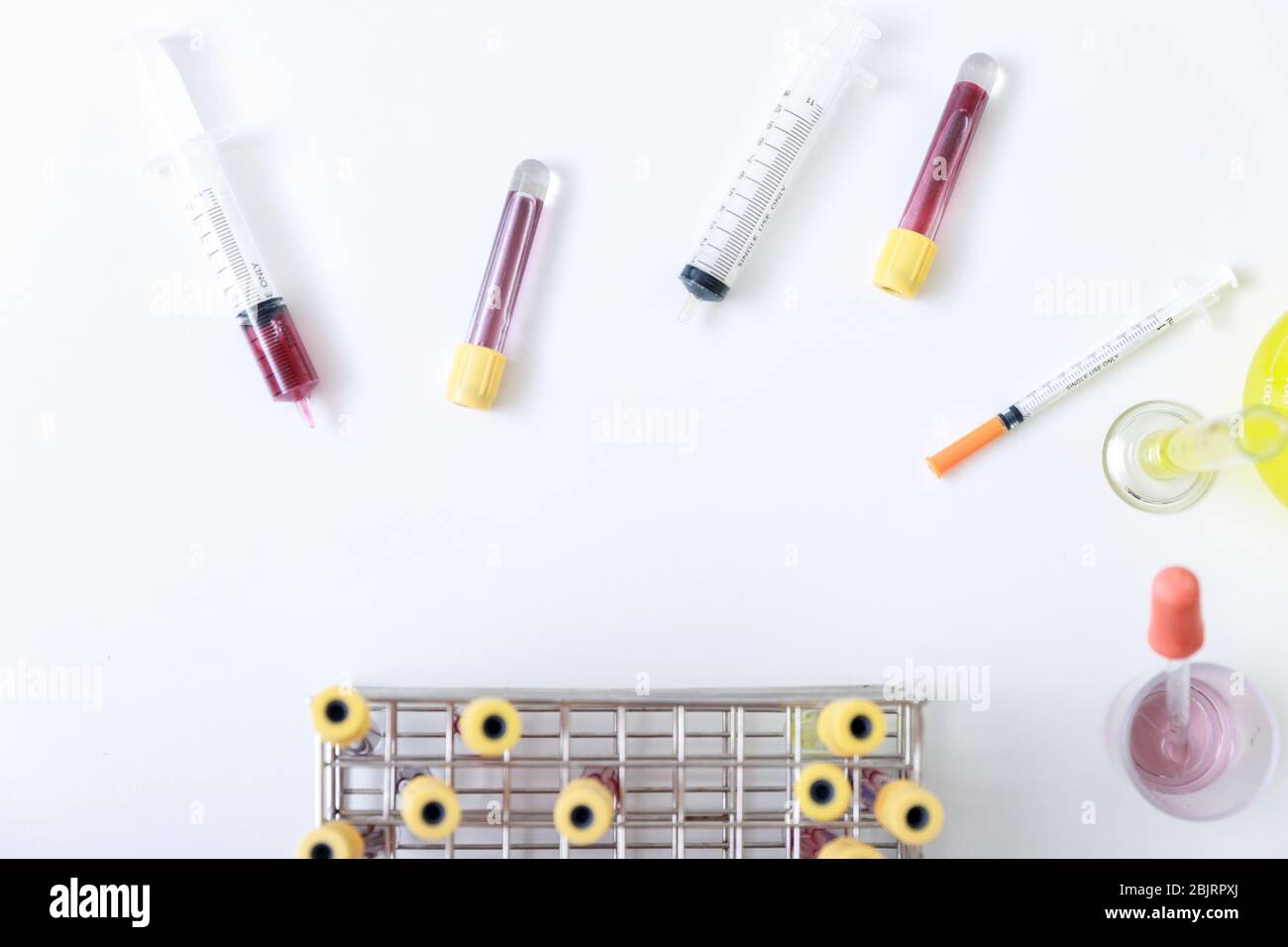 Top view of blood samples in tubes and syringes on work table in a ...