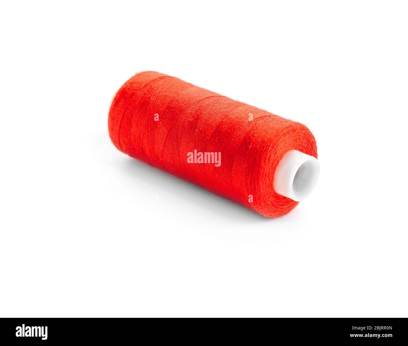 Spool of sewing thread on white background Stock Photo - Alamy