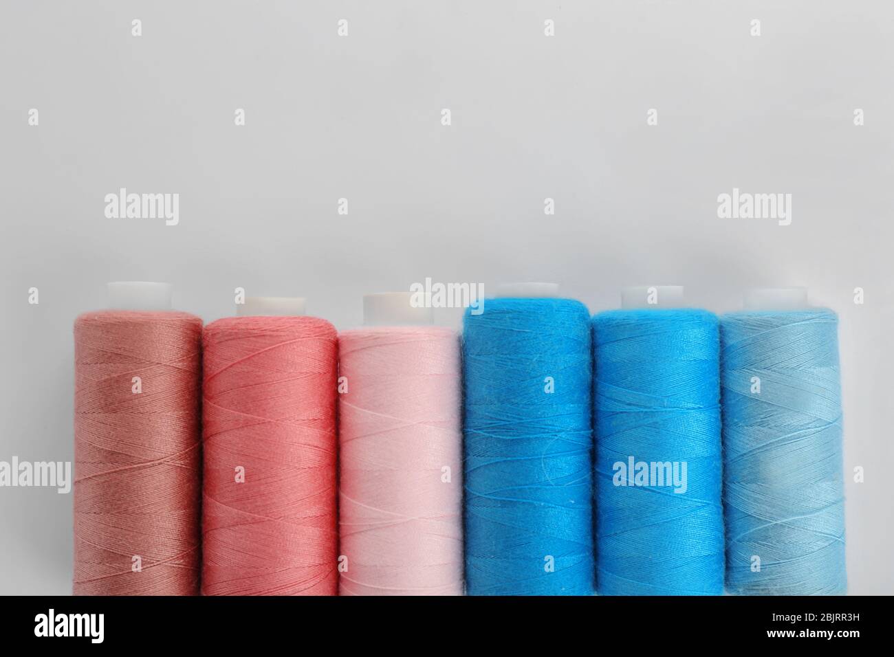 Set of colorful sewing threads on white background Stock Photo - Alamy